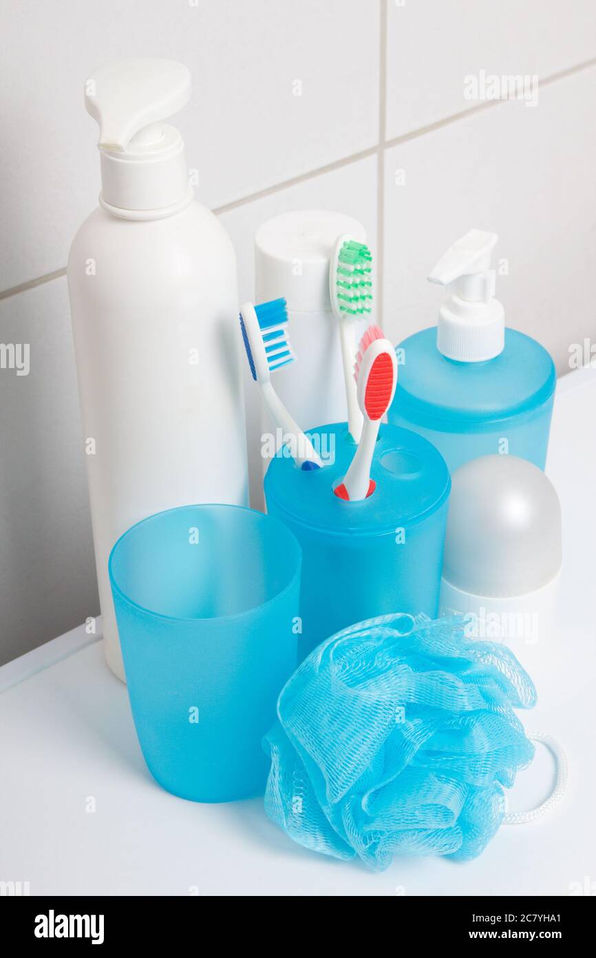 collection of blue hygiene supplies over tiled wall in bathroom Stock ...
