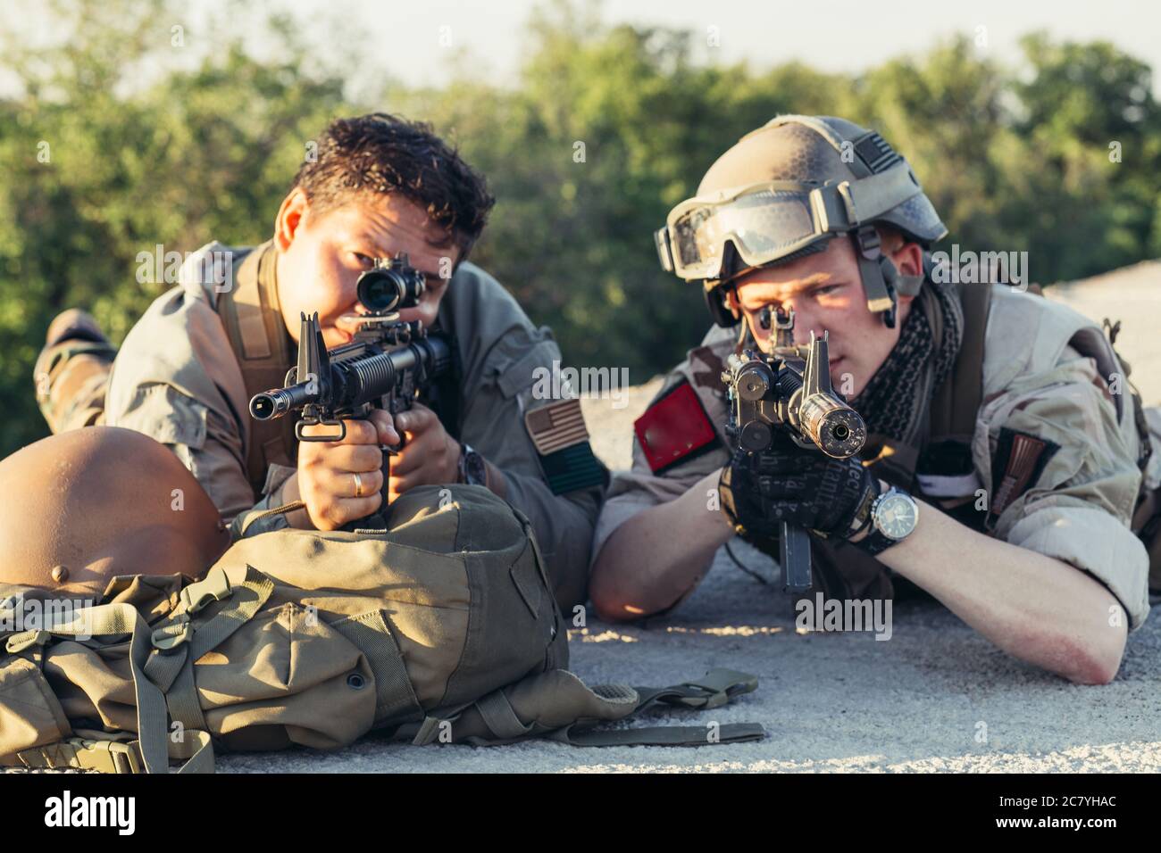 Pair of Army Rangers with rifle and machine gun moving along the ...