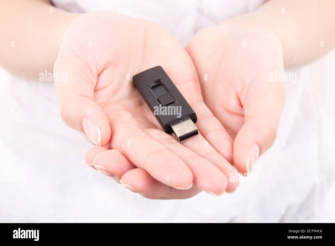 young woman hands holding black flash drive Stock Photo - Alamy