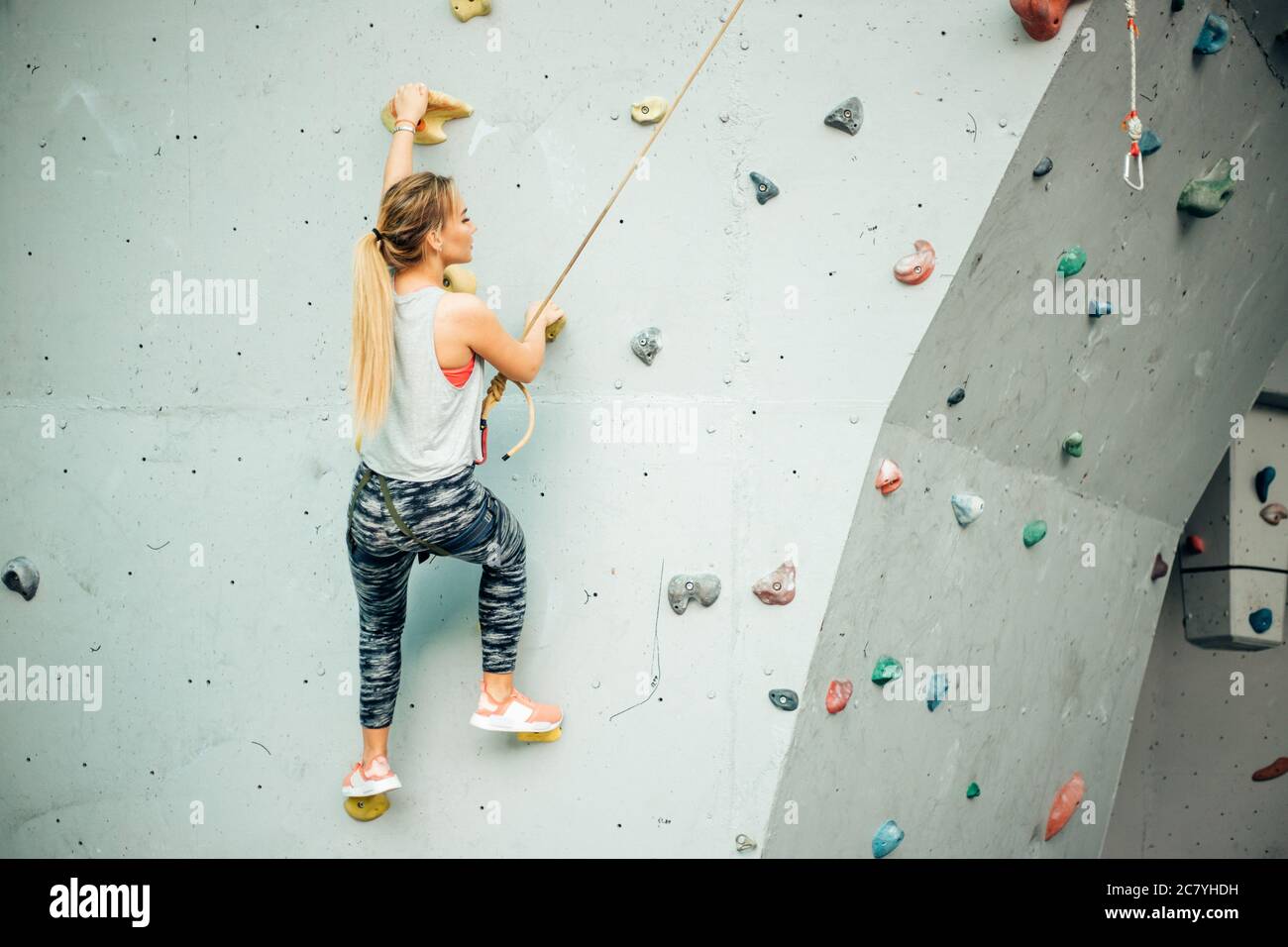 Back view of sportswoman climbing in the gym Stock Photo - Alamy