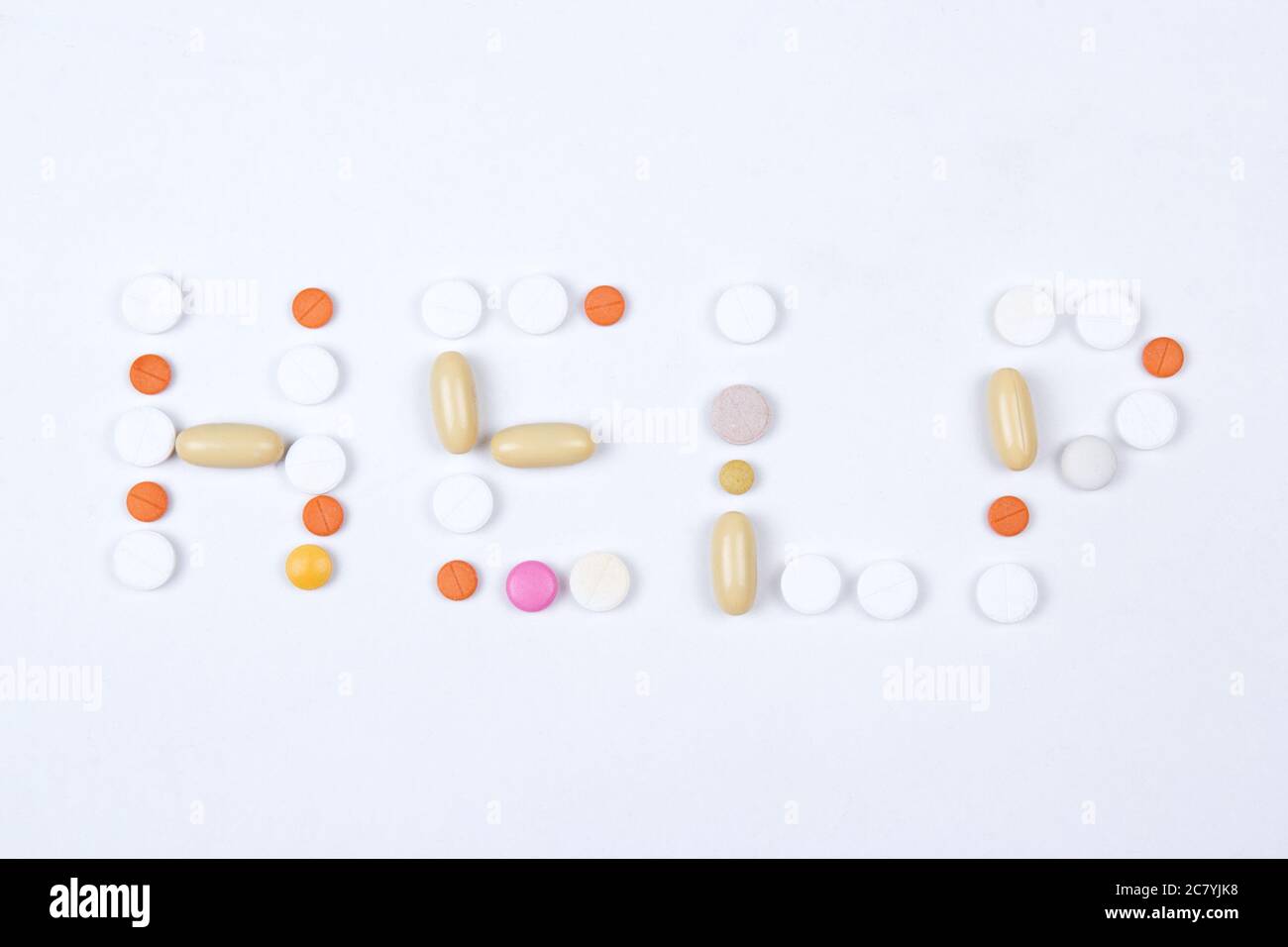 help word text made of colorful tablets, pills and capsules over white ...