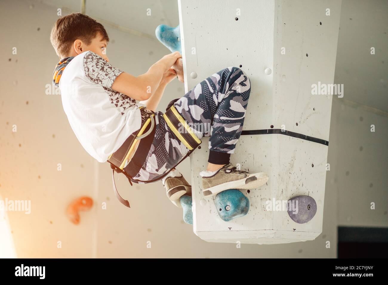 little boy climbing a rock wall indoor Stock Photo - Alamy