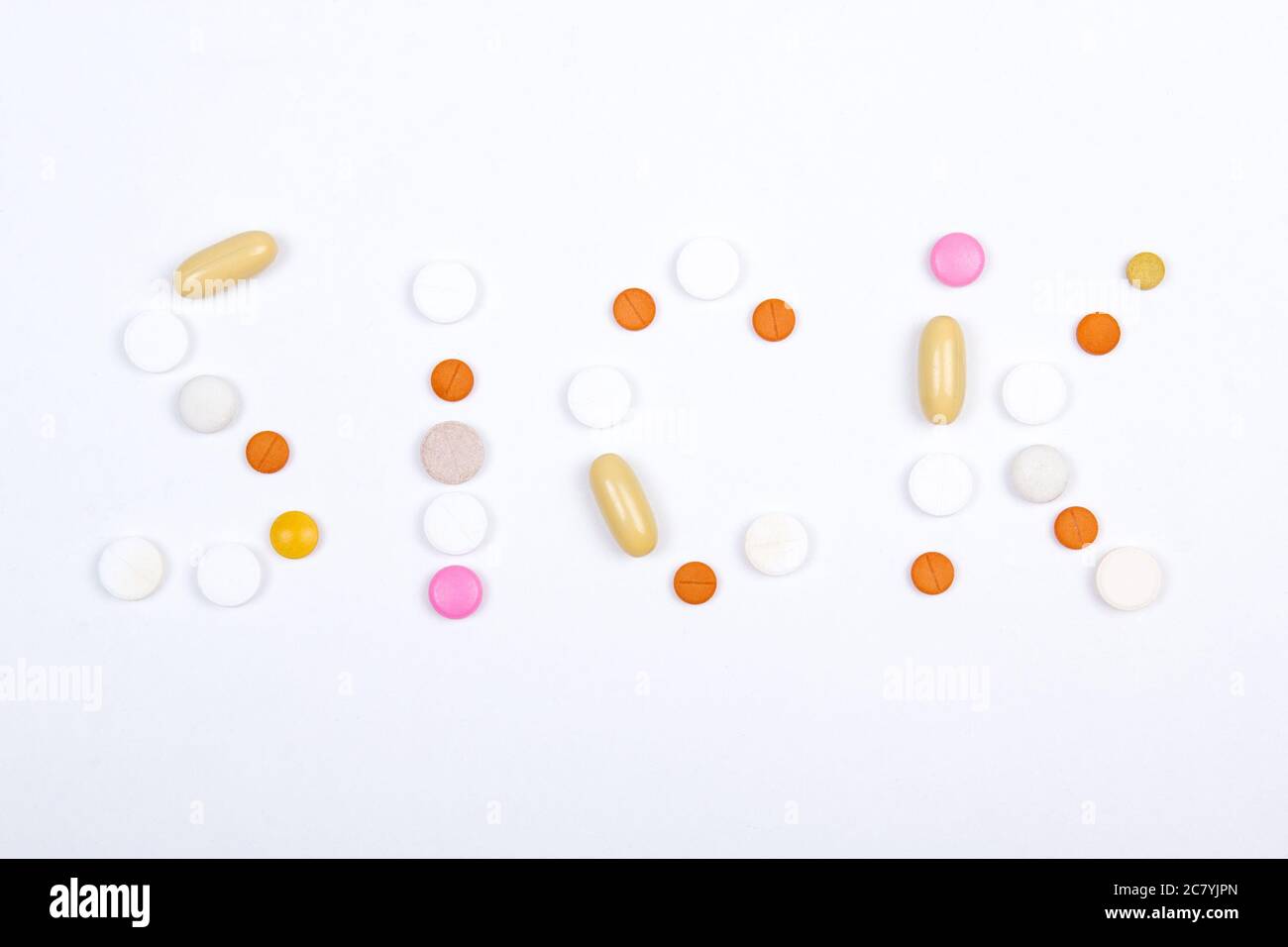 sick word text made of colorful tablets, pills and capsules over white ...