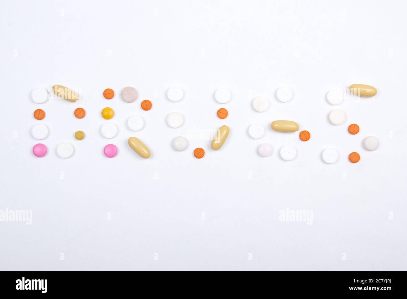 drugs word text made of colorful tablets, pills and capsules over white ...
