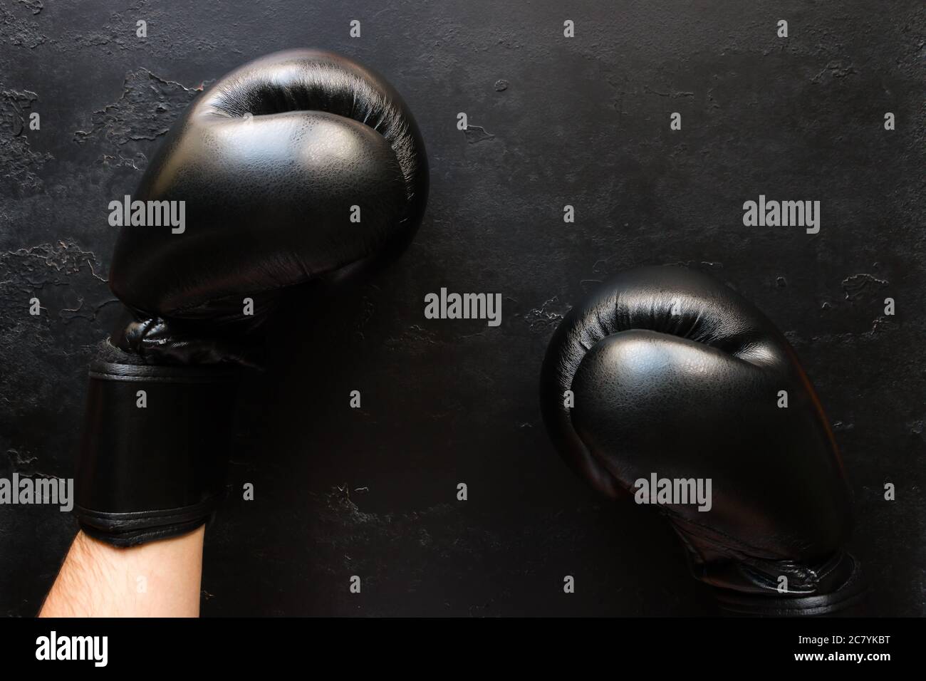 man in boxing gloves on a black background Stock Photo - Alamy