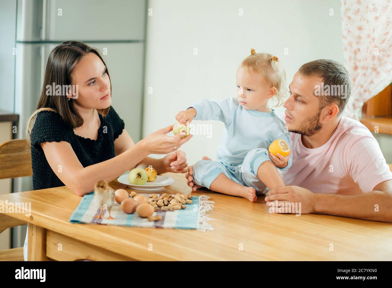 Cute sweet little child playing with little chicks at home with her ...