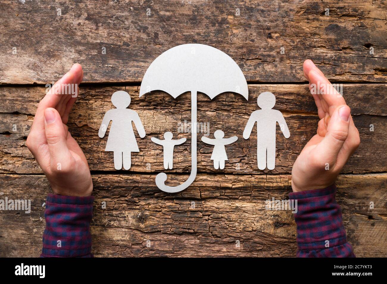 silhouettes of a family under an umbrella concept protection, insurance ...