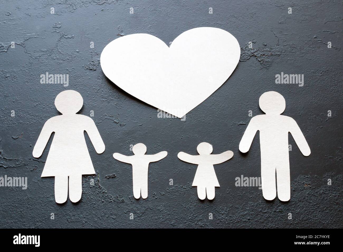 paper family and heart on a black background Stock Photo - Alamy