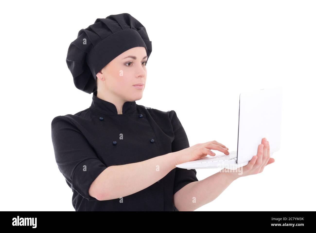 young chef woman in black uniform with laptop isolated on white ...