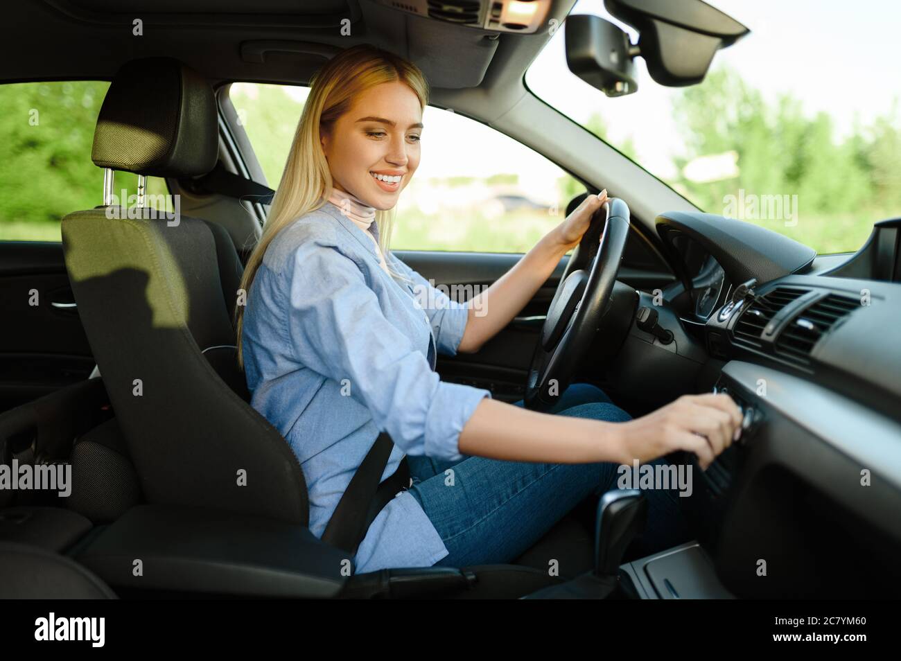 Smiling female student in the car, driving school Stock Photo - Alamy