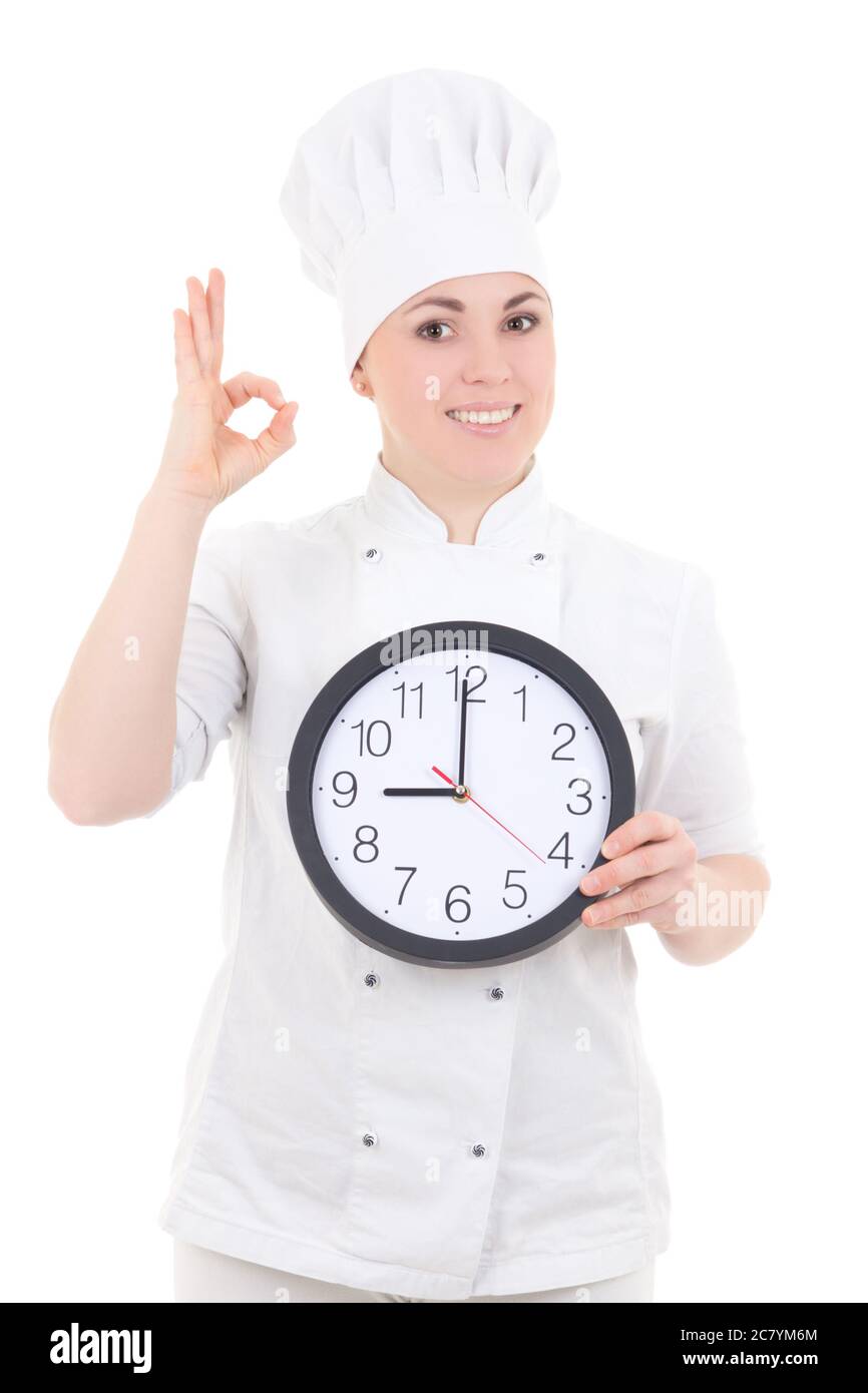portrait of young cook woman in uniform with clock showing ok sign ...
