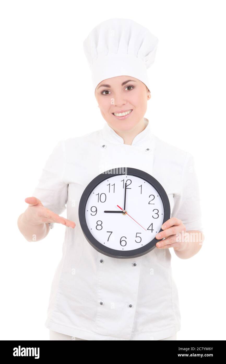 portrait of young cook woman in uniform showing clock isolated on white ...