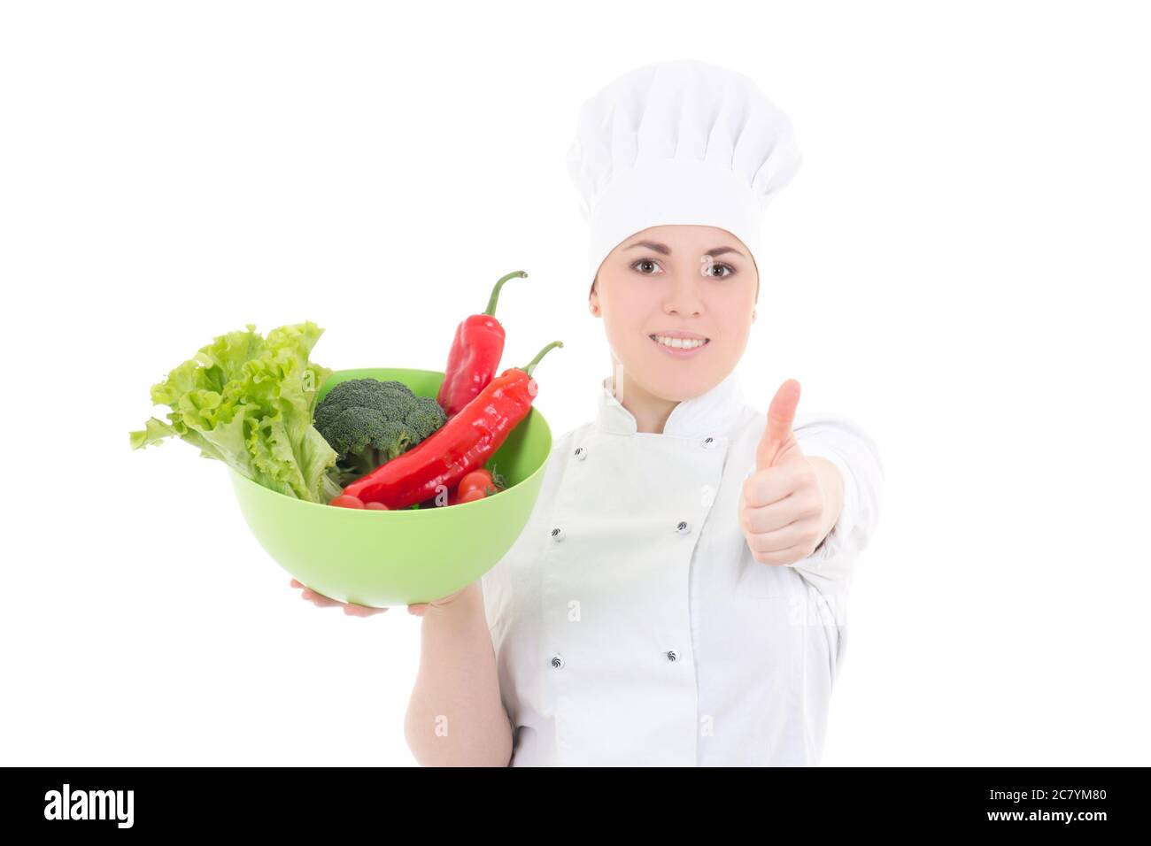 young attractive cook woman in uniform with vegetables thumbs up ...