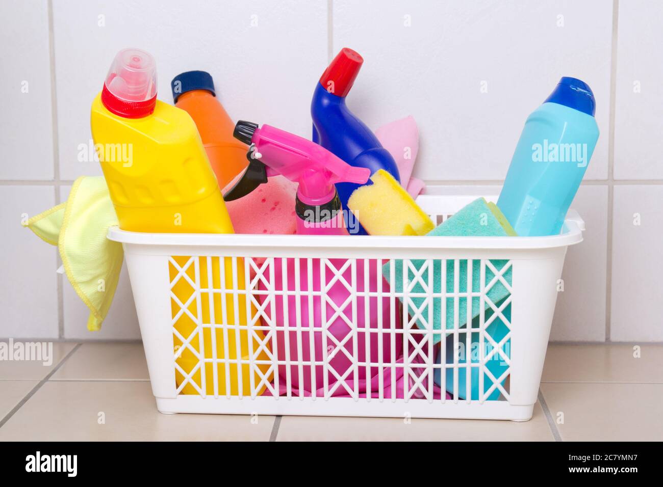 cleaning supplies in plastic box on tiled floor in bathroom Stock Photo ...