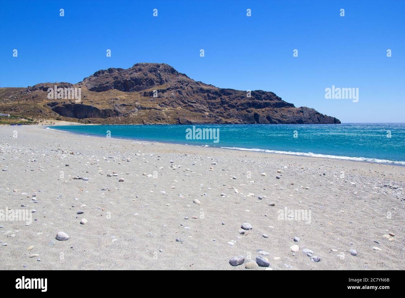 sandy beach with blue transparent water on Crete island Stock Photo - Alamy