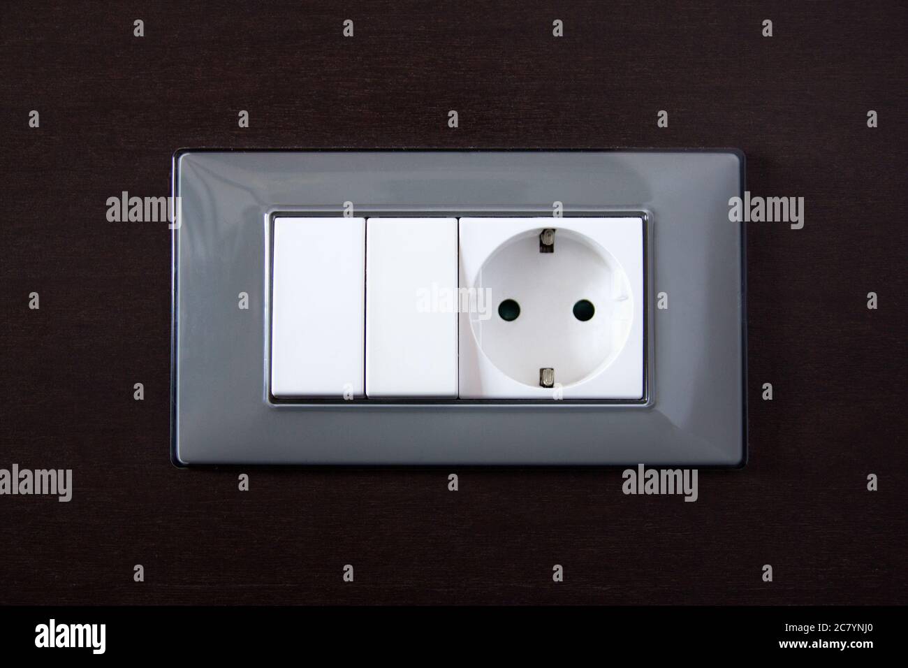 power outlet and light switch over wooden wall Stock Photo - Alamy
