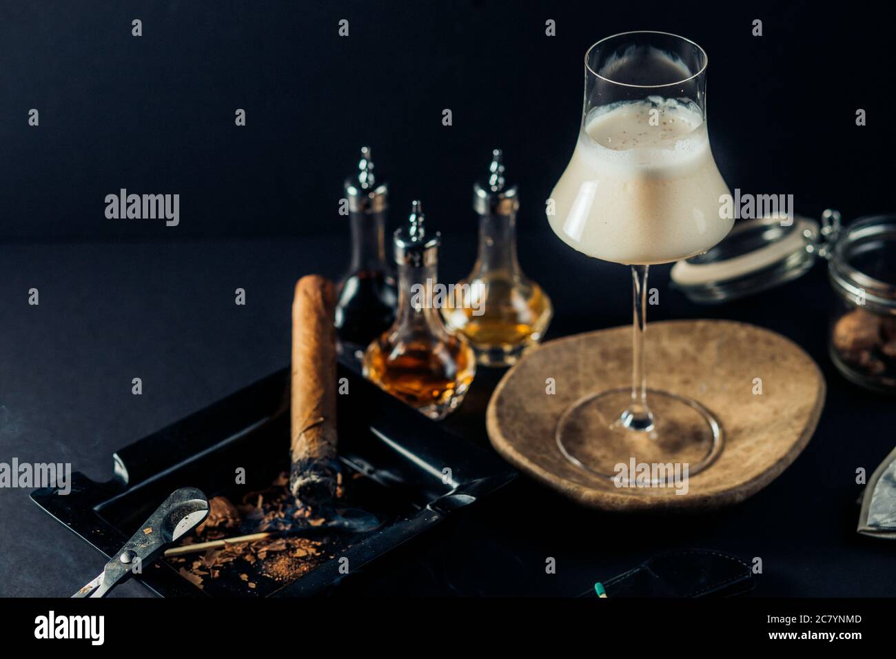 colorful cocktail with a cigar on a beautiful composition with drops ...