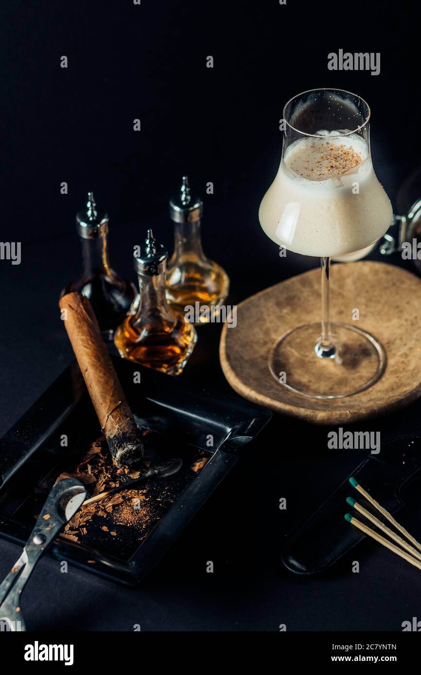 colorful cocktail with a cigar on a beautiful composition with drops ...