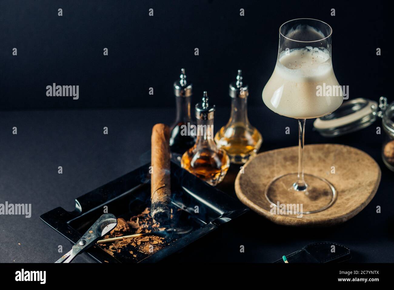 colorful cocktail with a cigar on a beautiful composition with drops ...