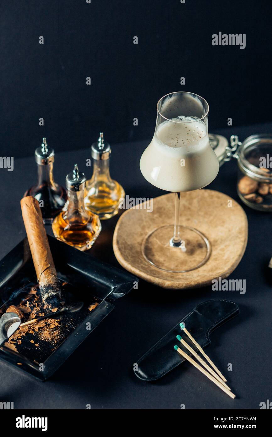 colorful cocktail with a cigar on a beautiful composition with drops ...