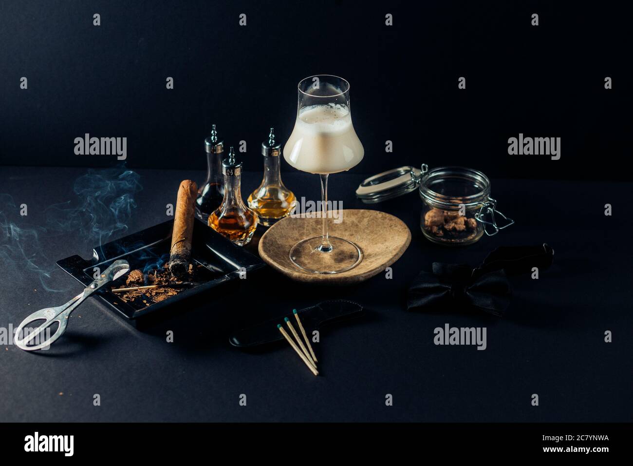 colorful cocktail with a cigar on a beautiful composition with drops ...