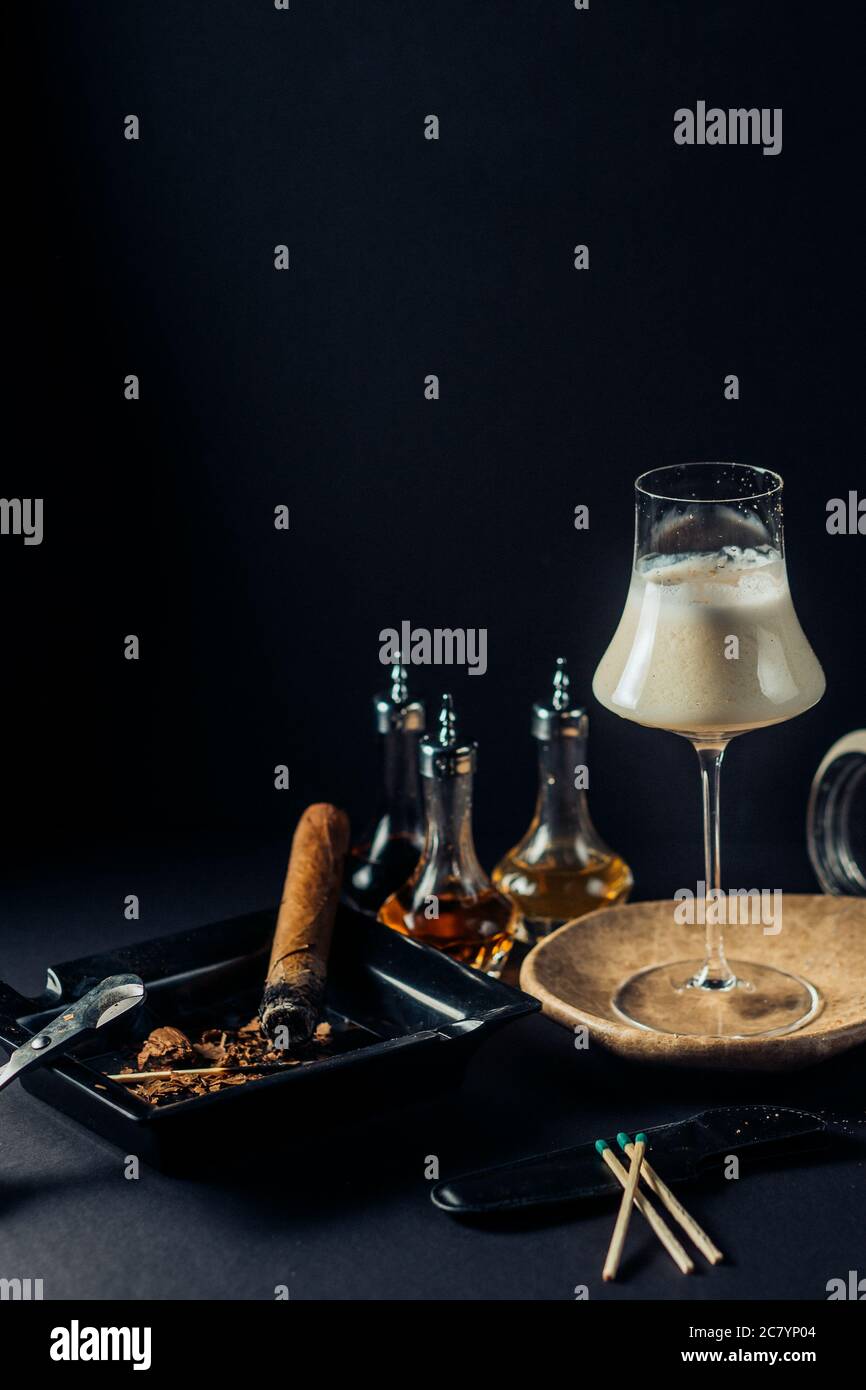 colorful cocktail with a cigar on a beautiful composition with drops ...