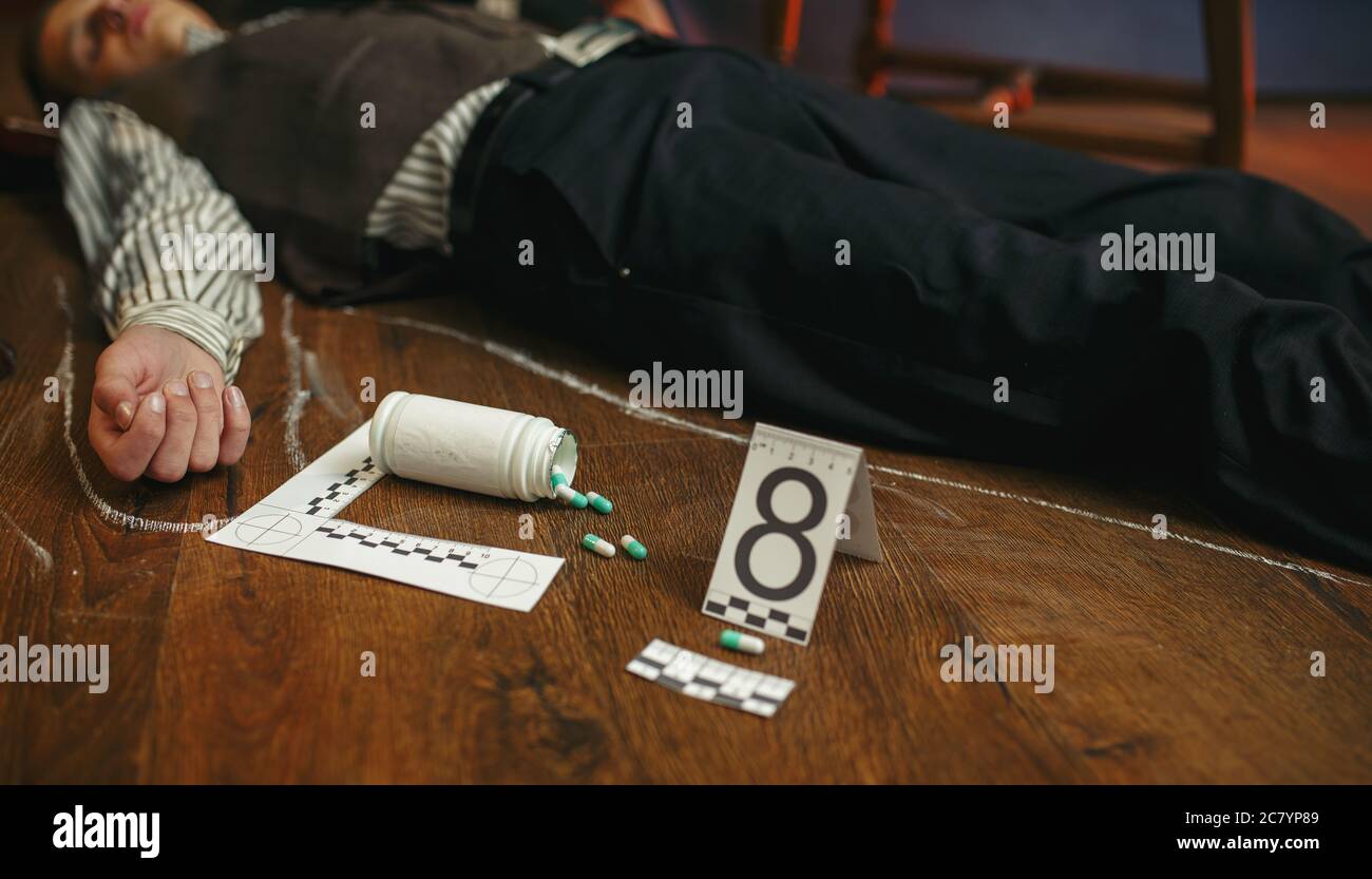 Dead man and bottle of pills at the crime scene Stock Photo - Alamy