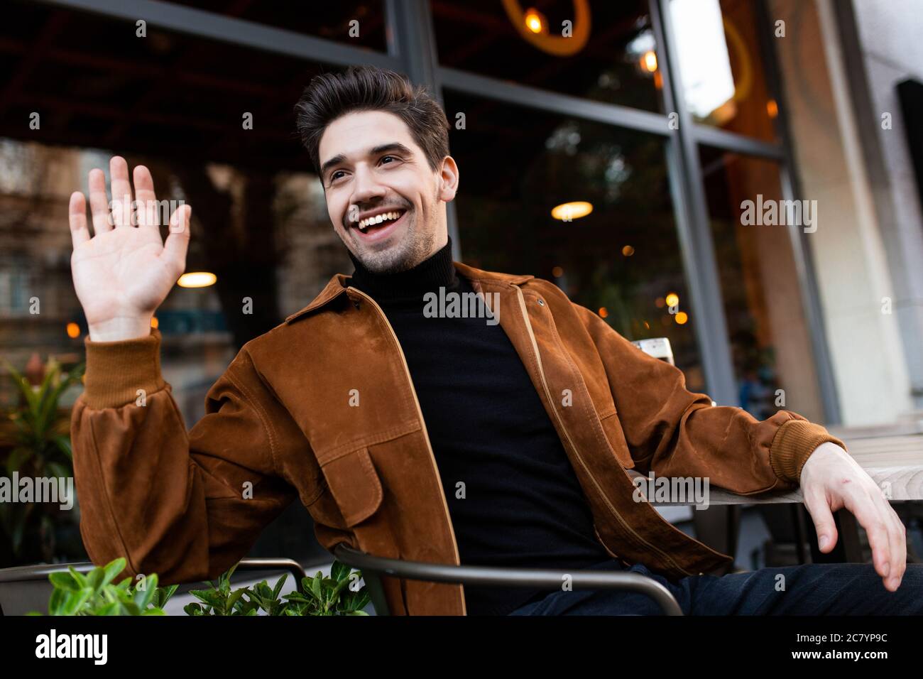 Happy man greeting waving hand hi-res stock photography and images - Alamy
