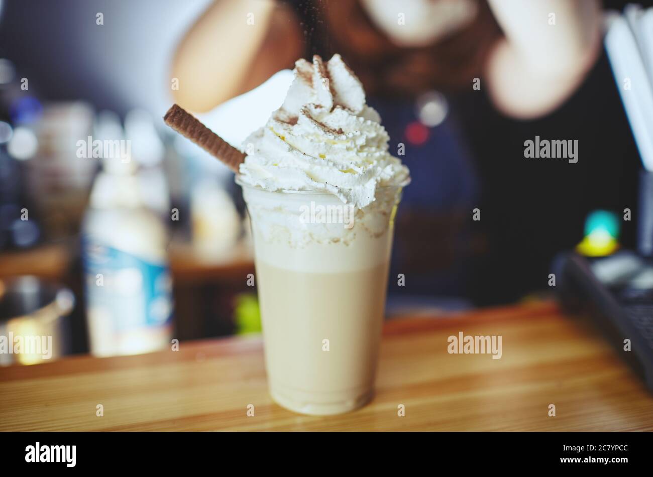 Barista making frappe - iced latte coffee with caramel and chocolate ...