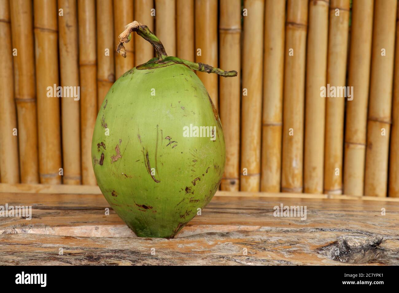 Fresh young coconut on table with massive wooden board. Young Coconut ...