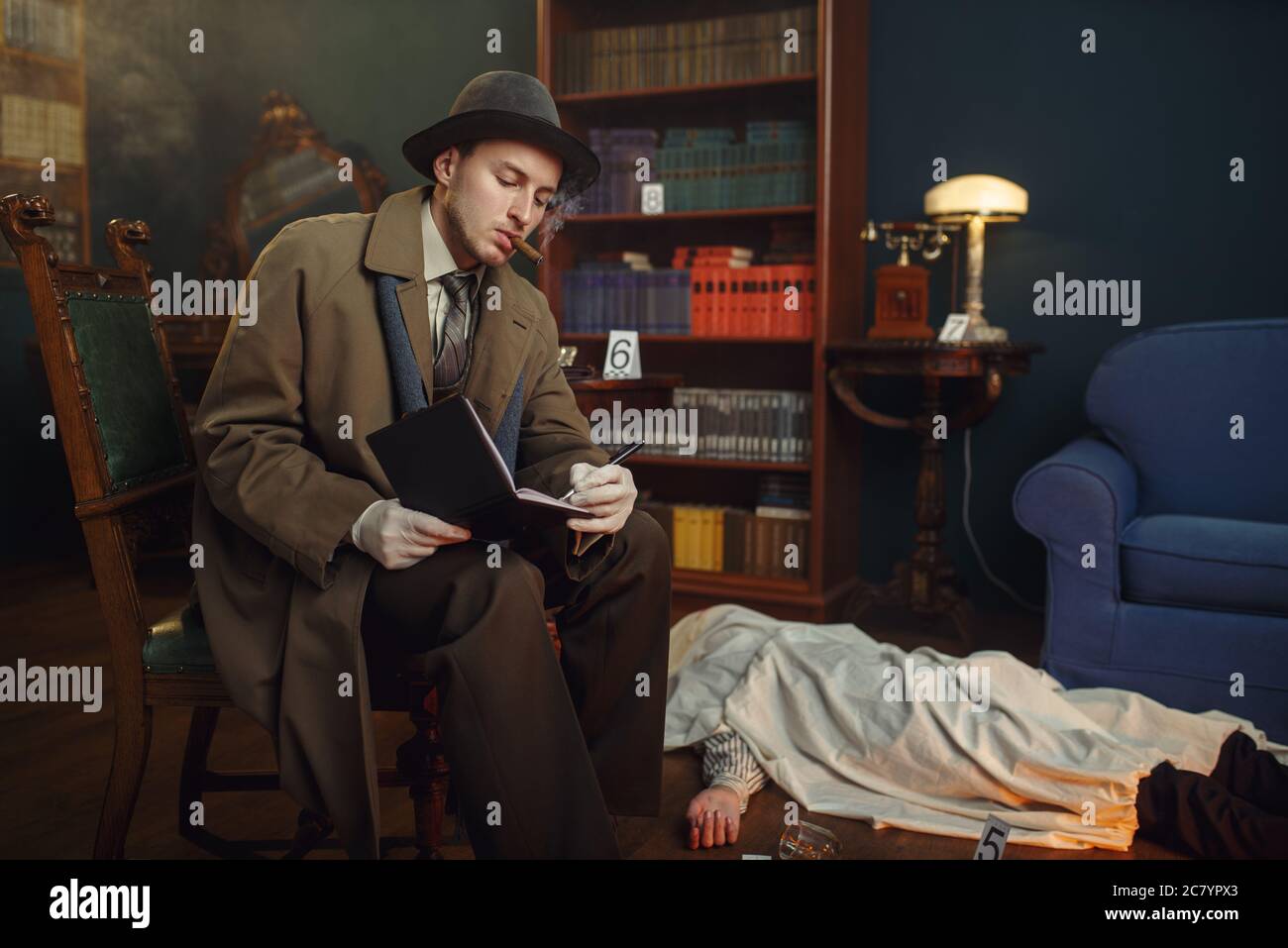 Male detective with cigar writes in notebook Stock Photo - Alamy