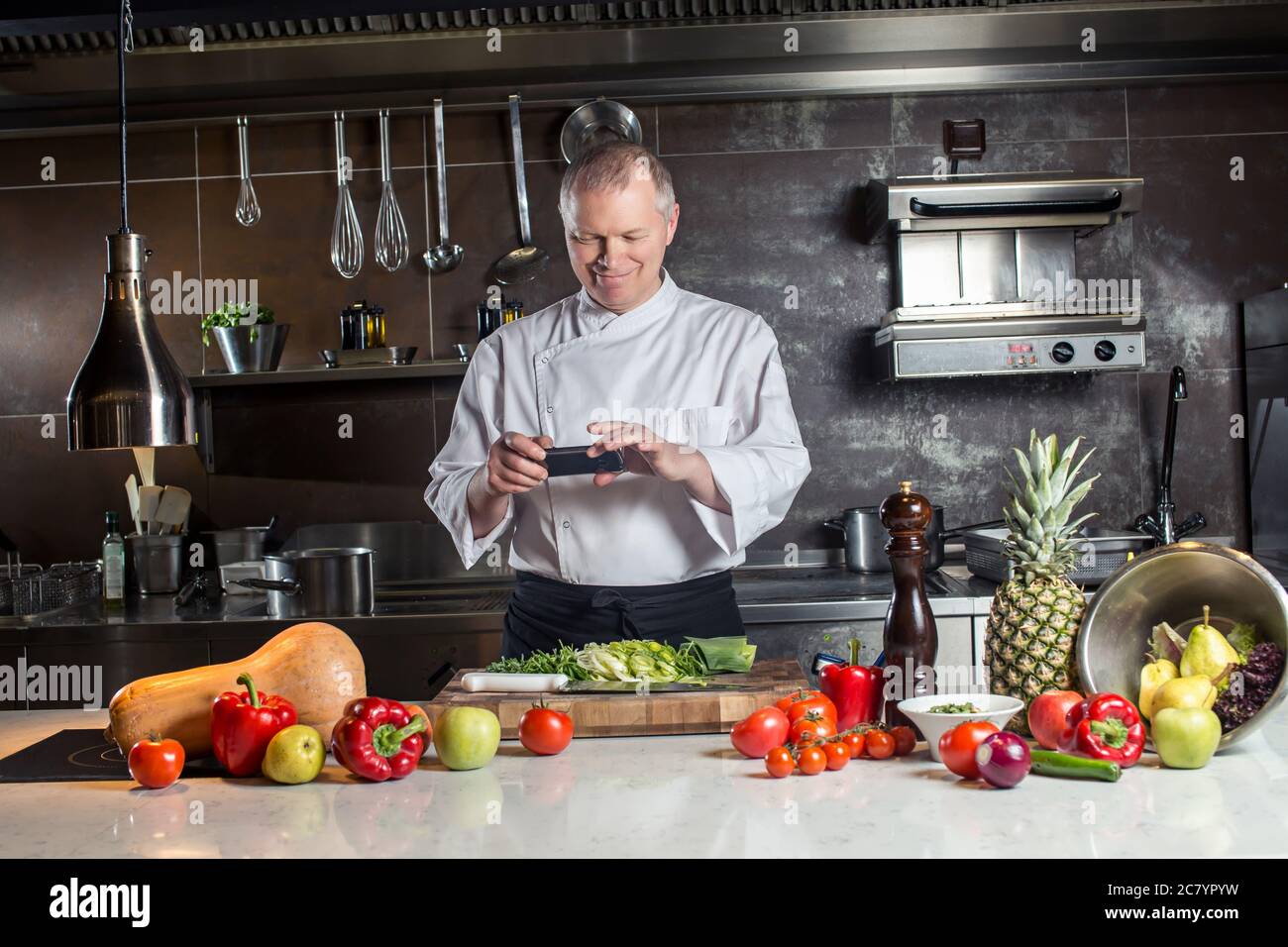 chef shooting with his cell phone camera his cooked food Stock Photo ...