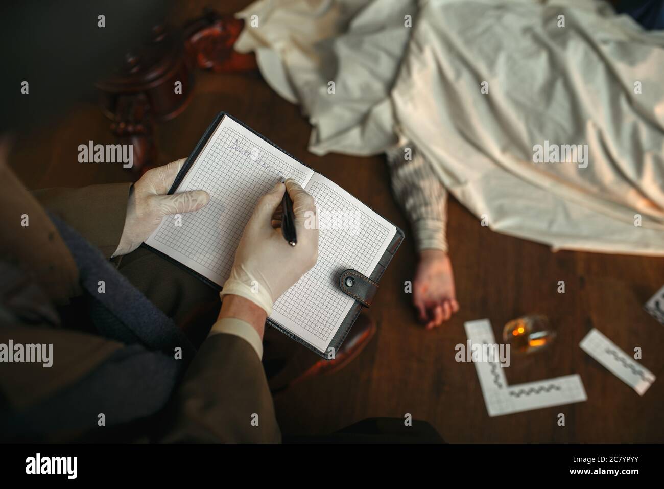 Male detective with cigar writes in notebook Stock Photo - Alamy
