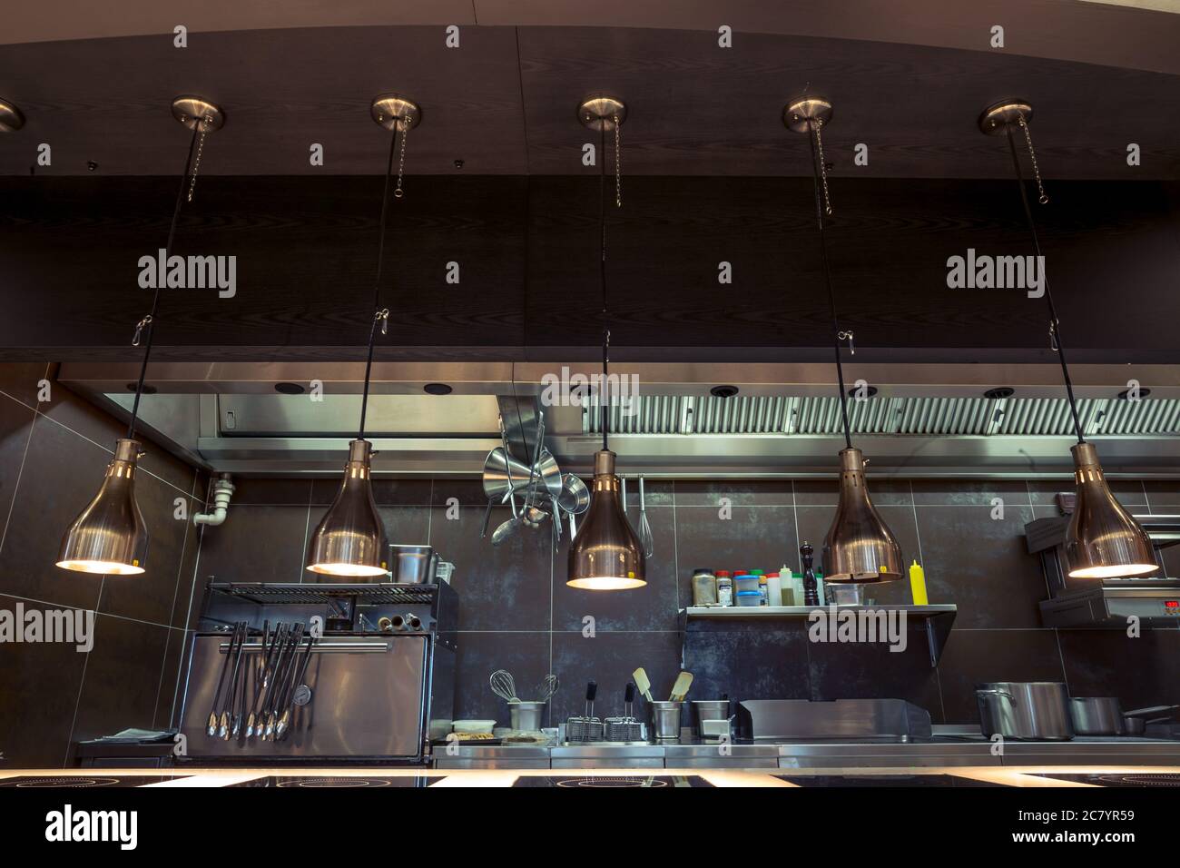 Variety of utensils on counter in commercial kitchen Stock Photo - Alamy