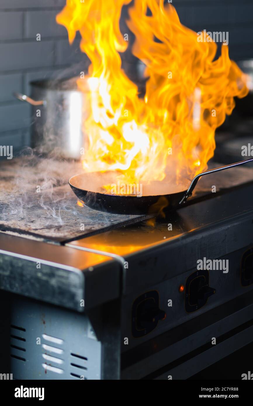 Fire burn is cooking on iron pan,stir fire very hot Stock Photo - Alamy