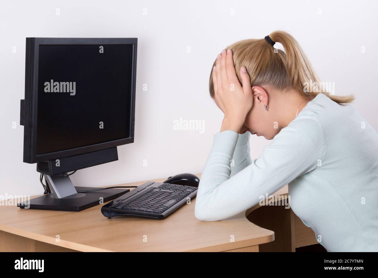 back view of stressed woman with personal computer at work in office ...