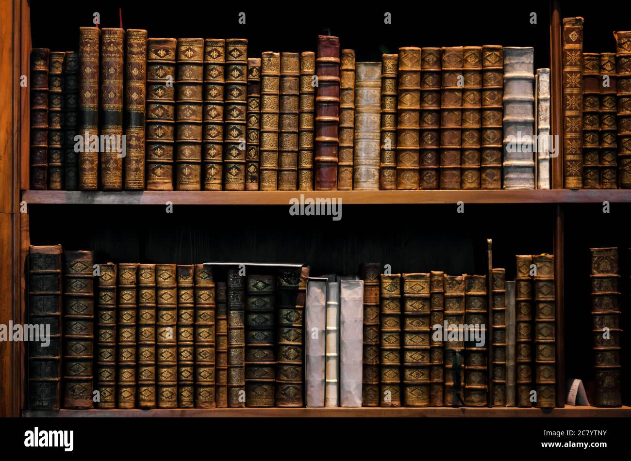 Ancient tomes on an antique wooden bookshelf Stock Photo - Alamy