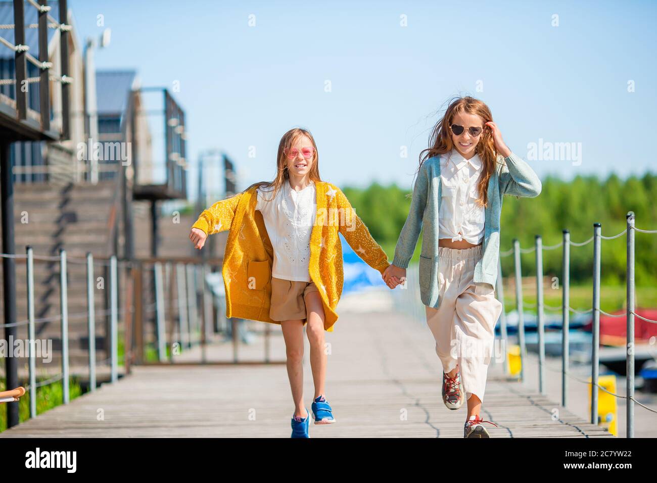 Adorable little girls in port on vacation Stock Photo - Alamy