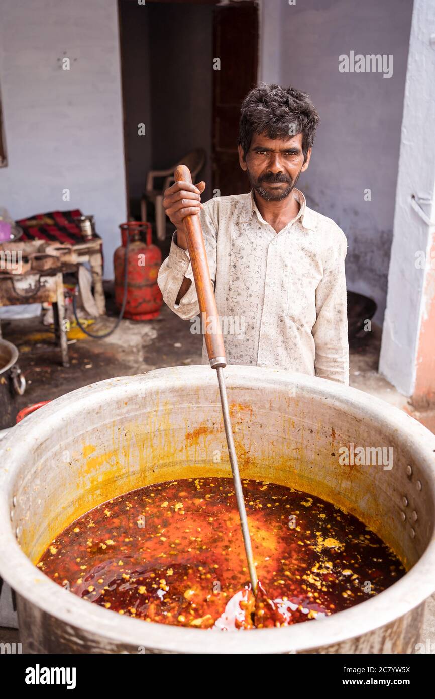Agra / India - February 13, 2020: Indian man preparing spicy food in a ...