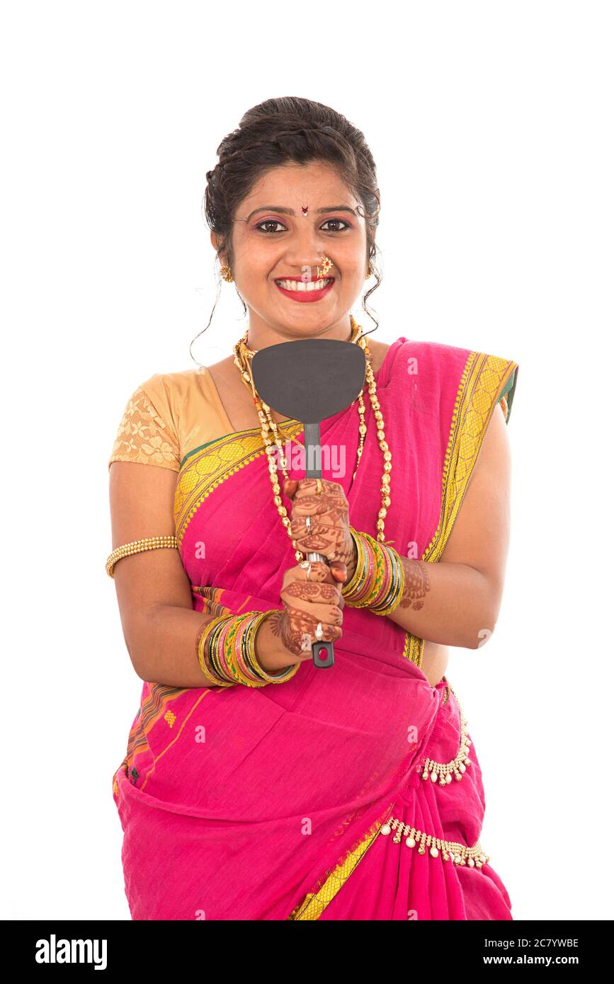 Young Traditional Indian Girl holding kitchen utensil on white ...