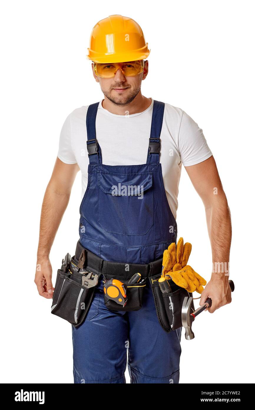 Young caucasian repairman worker in yellow hard hat and uniform holding ...