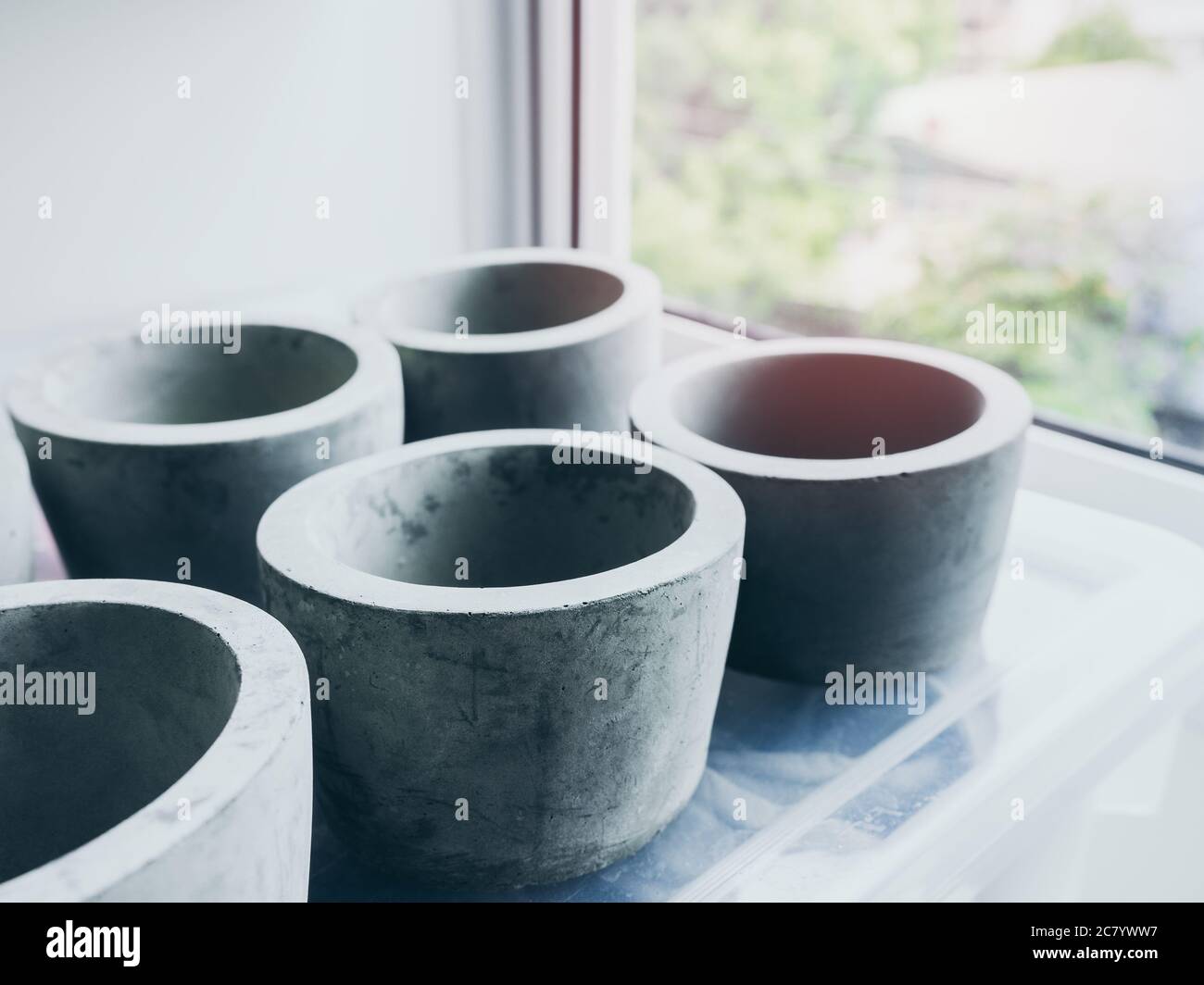 Empty round concrete pots. Close-up empty cement planters on table near ...