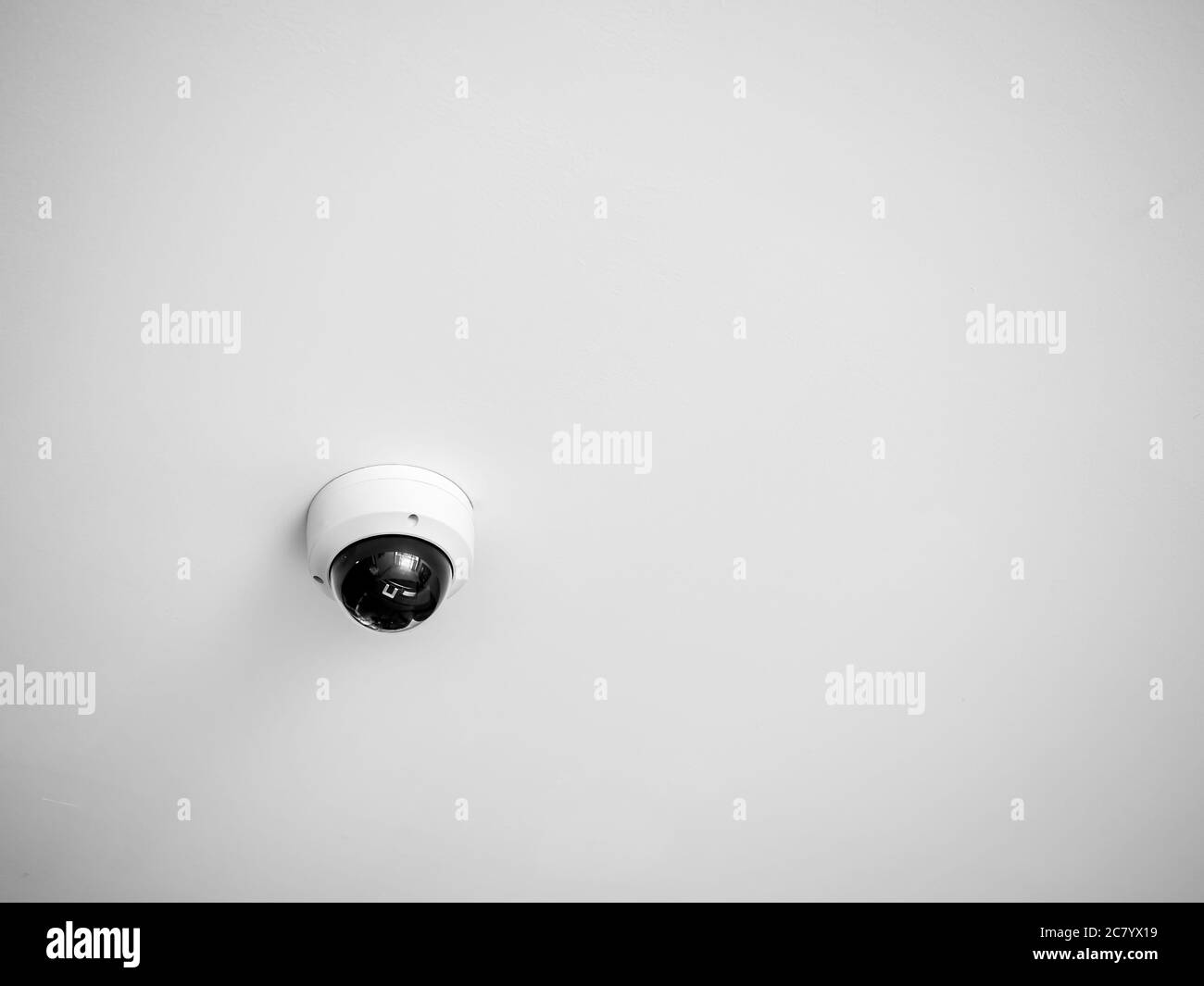 CCTV system security. Round CCTV camera on white ceiling in the ...