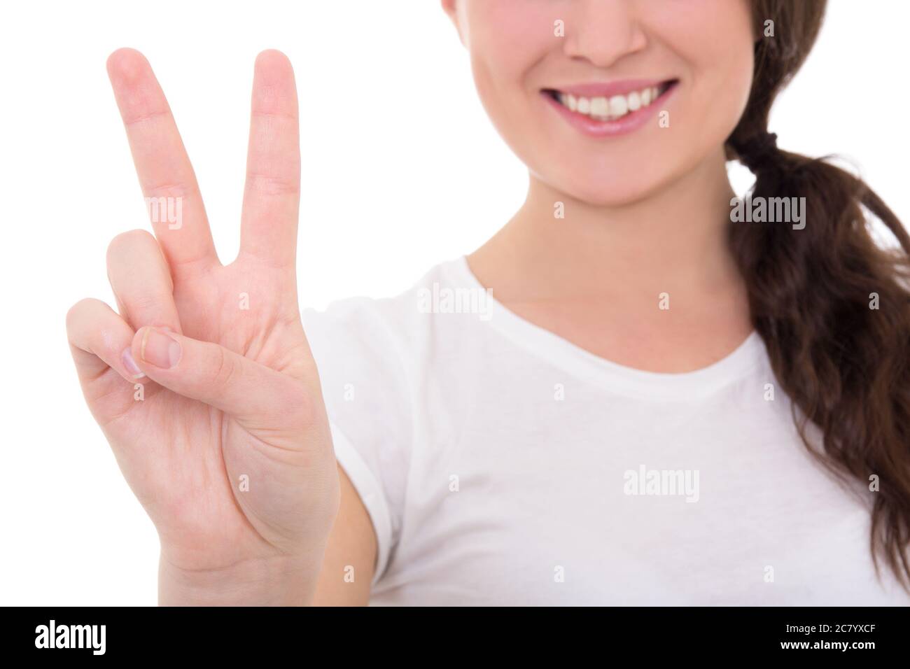 young smiling woman giving peace sign isolated on white background ...