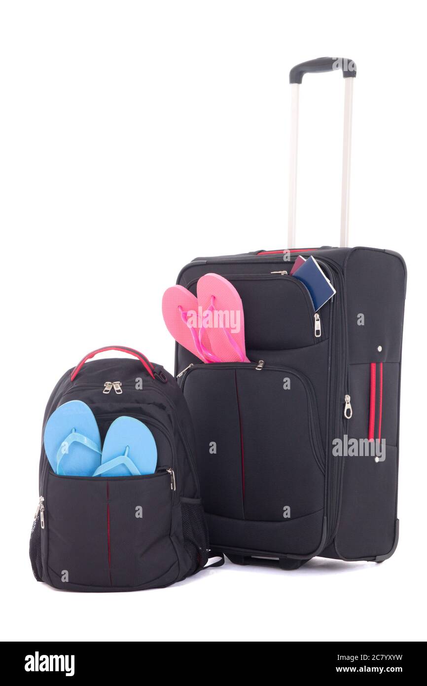 travel suitcase and backpack with beachwear isolated on white ...