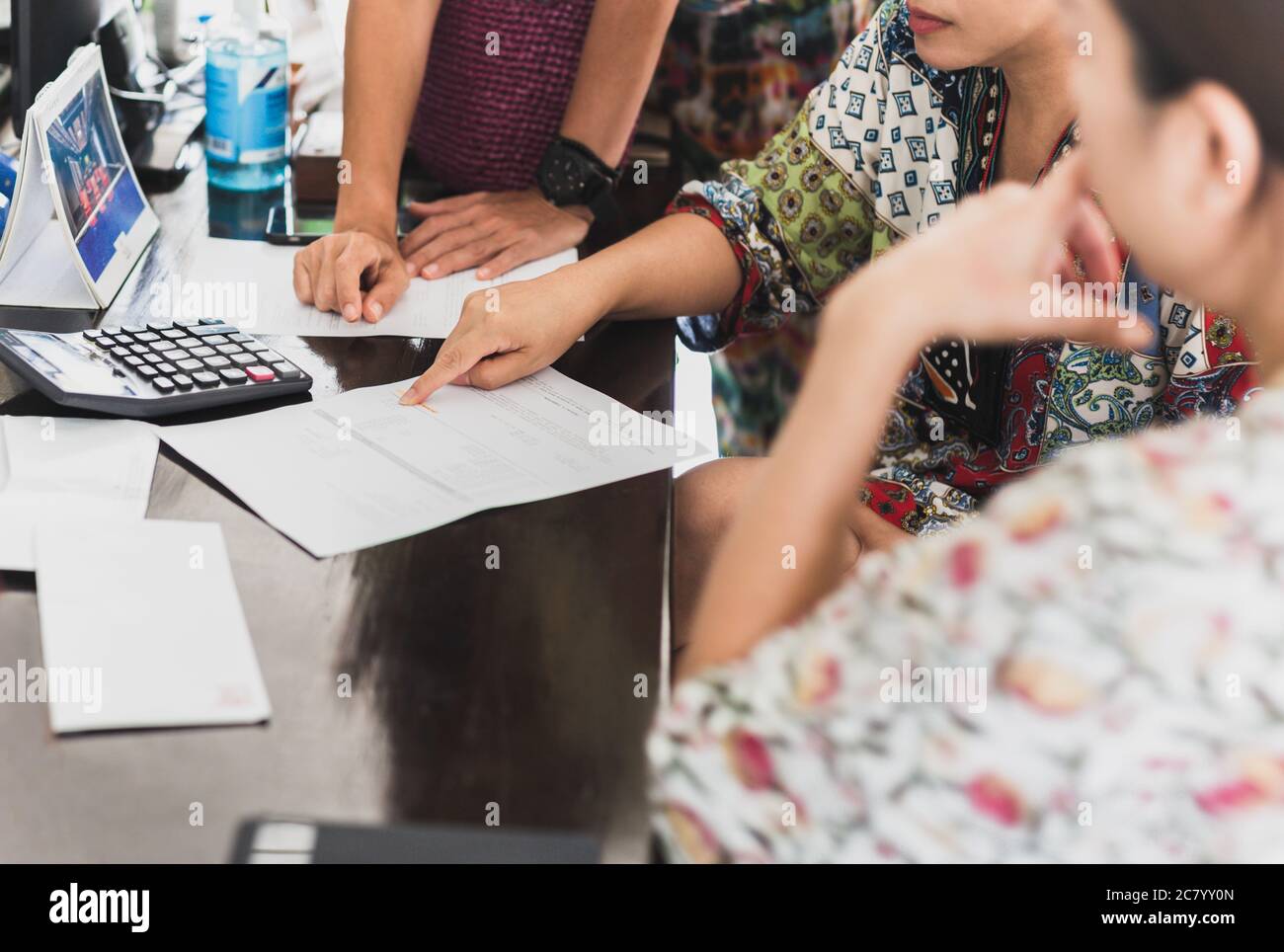Group of tourist woman discuss details of payment receipt at hotel ...