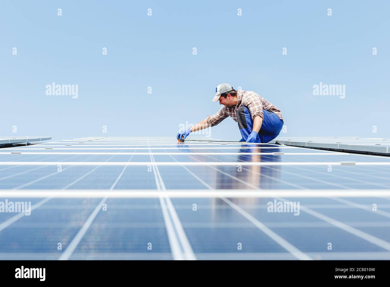 Solar panel energy. Electrical engineer man is working in solar station ...
