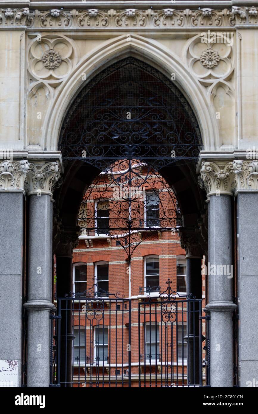 Red Brick mansion seen through an elaborate brick work arch and gate in ...