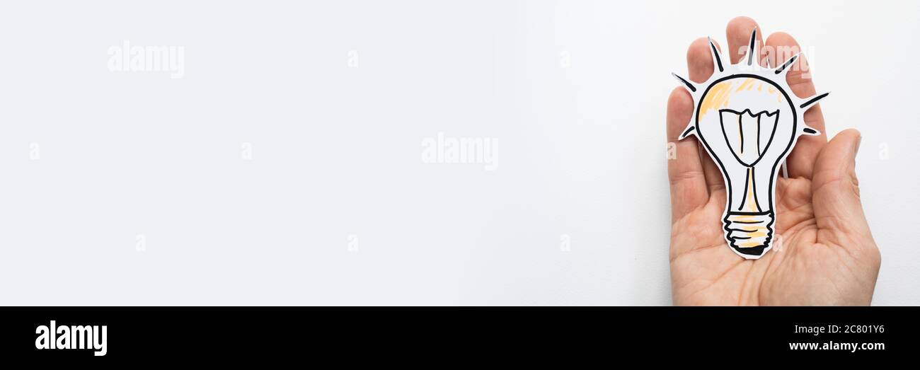 Paper light bulb icon in hand Stock Photo - Alamy