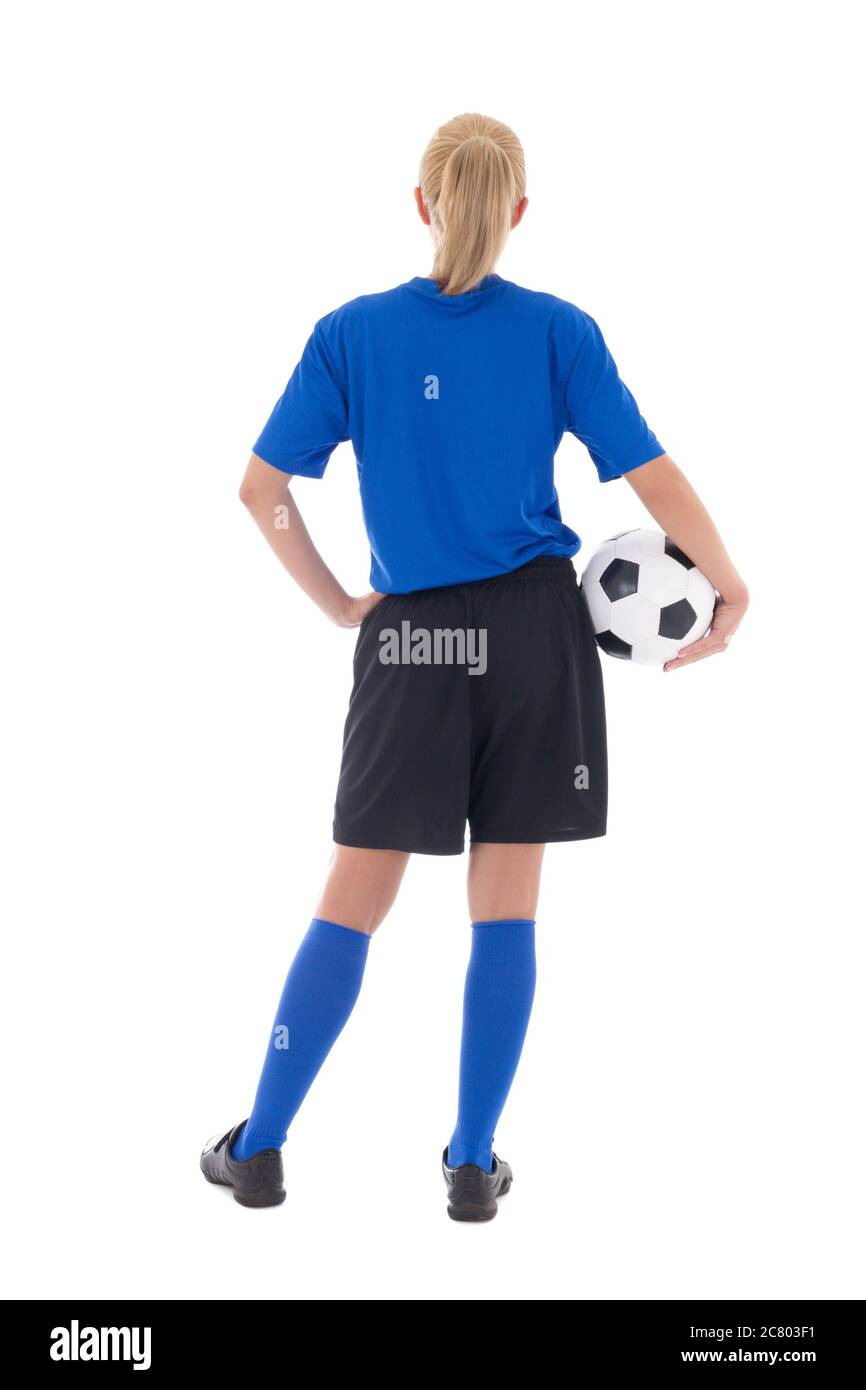 back view of young female soccer player in blue uniform with ball ...